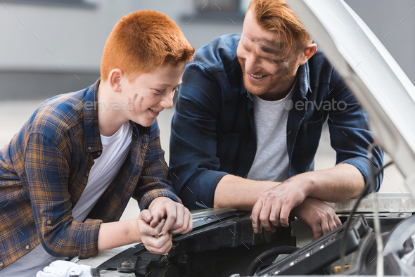 happy father and son repairing car with open hood Stock Photo by ...