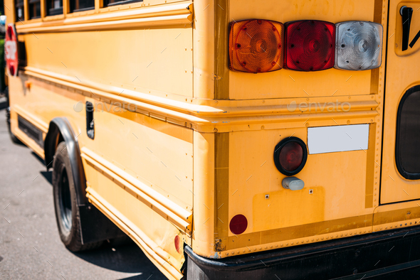 rear view of traditional yellow school bus Stock Photo by LightFieldStudios
