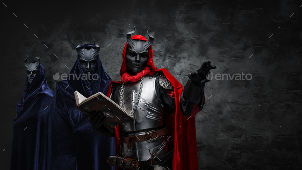 Dark cultists with robes and masks against dark background Stock Photo ...