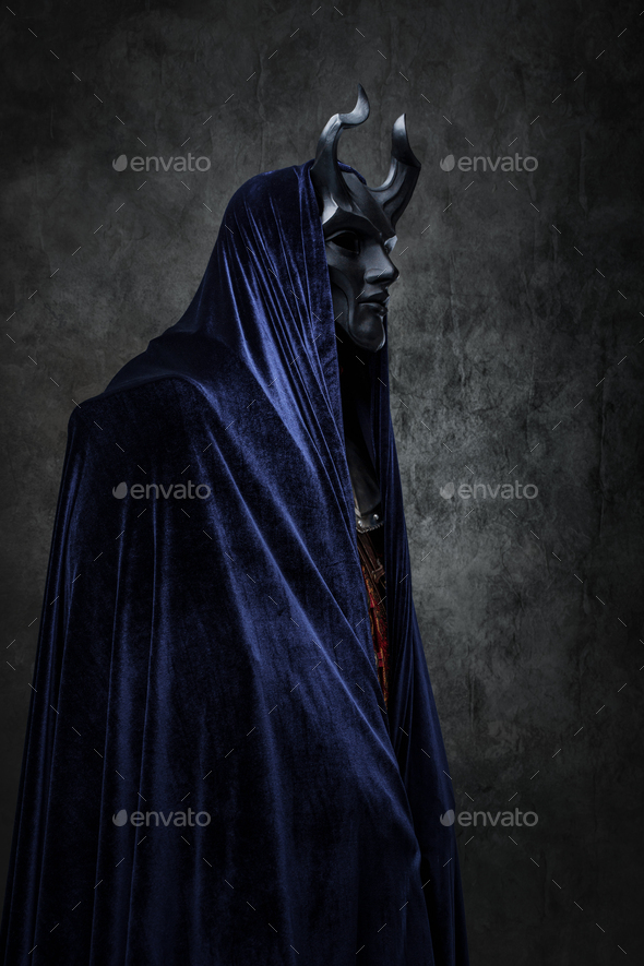Evil cultist with dark cloak against dark background Stock Photo by ...