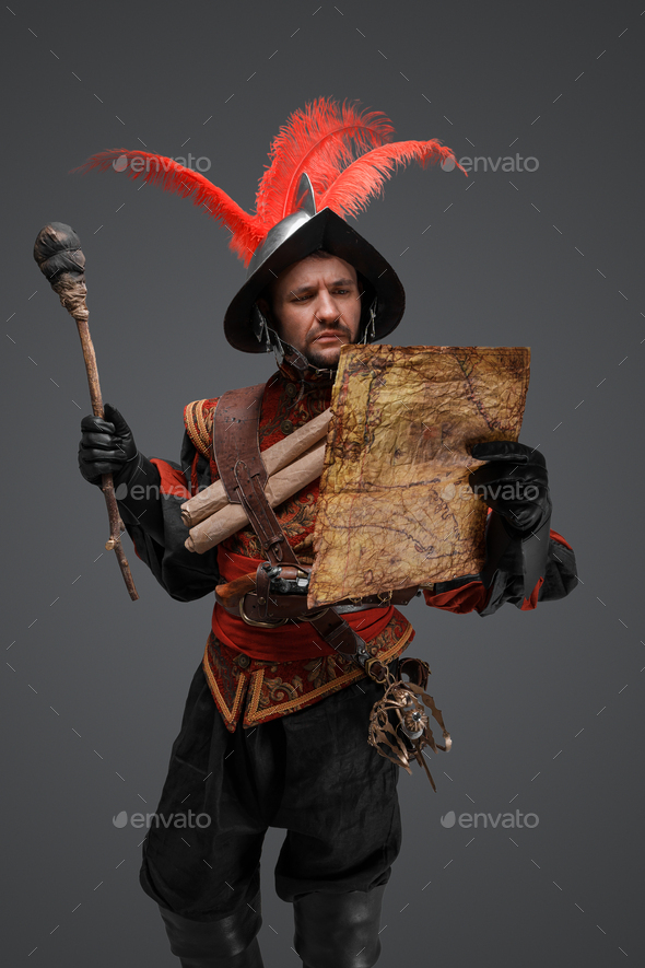 Medieval conquistador explorer with antique map and torch Stock Photo ...