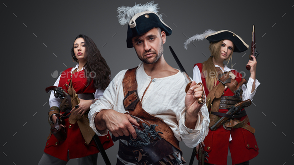 Stylish pirate man with two female pirates at his sides Stock Photo by ...