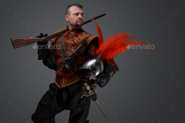 Stylish musketeer dressed in red costume holding rifle Stock Photo by ...