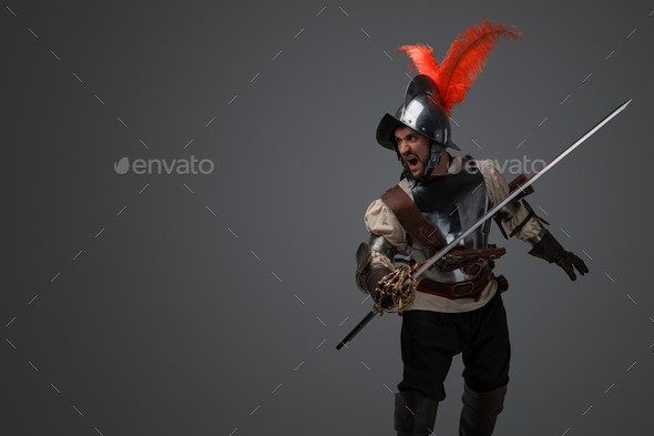 Violent conquistador dressed in plate armor holding sword Stock Photo ...