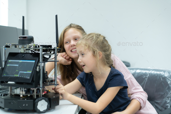 Children using the hand robot technology and having fun Learning Stock ...