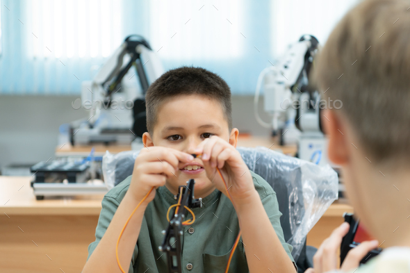 Children using the hand robot technology, Stock Photo by wosunan ...