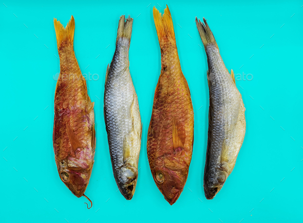 Dried fishes - Mullus and Mugil - on the table. Salty dry fish on a ...