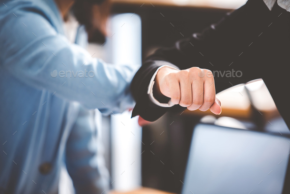 business people clashing hands It represents a new kind of teamwork ...