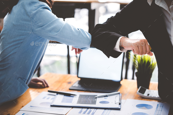 business people clashing hands It represents a new kind of teamwork ...