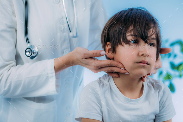 Endocrinology pediatrics specialist doing a medical checkup of lymph ...