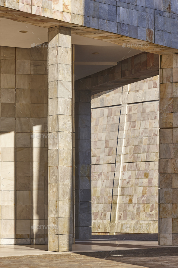 Stone tiles building facade with columns. Architecture and construction ...