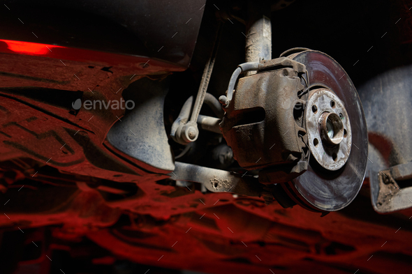 car front suspension arms, brake caliper and front wheel brake disc ...