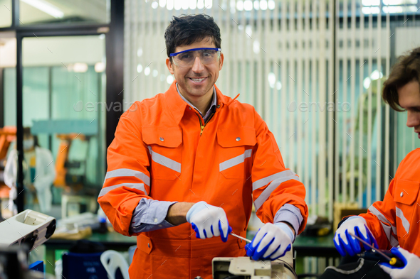 Professional technicians team checking parts of automatic robotic ...