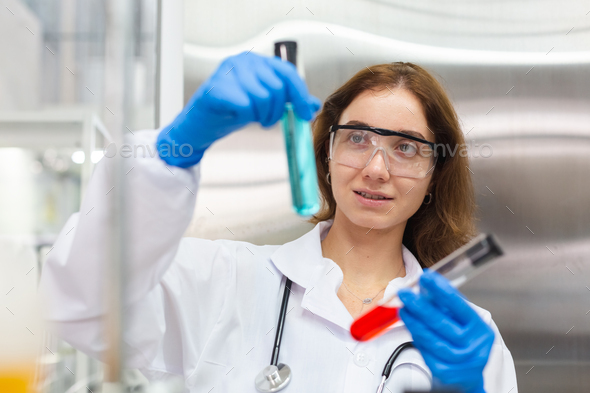Young women scientist are working research and test chemical with test ...