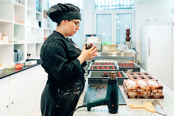 chef chocolatier works on the confection of artisanal chocolates in his ...