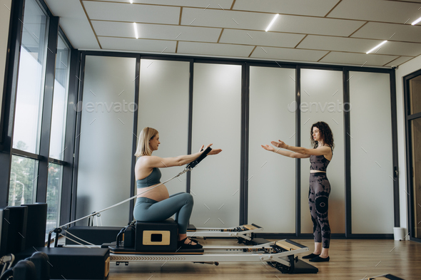 pregnant woman pilates reformer roll up cadillac exercise with personal ...