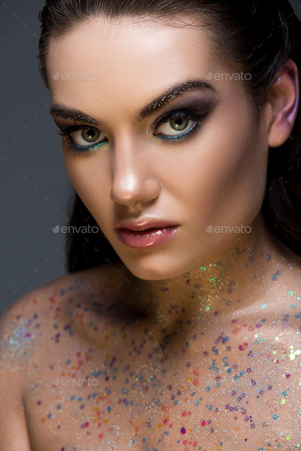 attractive glamorous model posing with glitter on body, isolated on ...