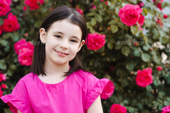 Cute smiling kid girl with rose flowers in park outdoor Stock Photo by ...