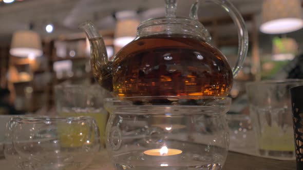 Glass teapot being heated with candle, Stock Footage | VideoHive