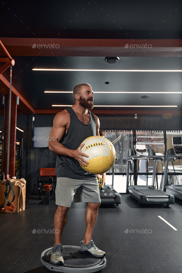 The guys tries to keep his balance on the balancing platform with ...