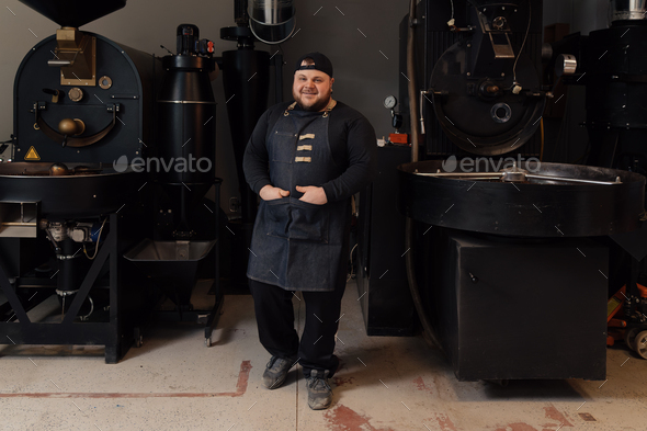Male worker standing near professional roasting machine Stock Photo by ...
