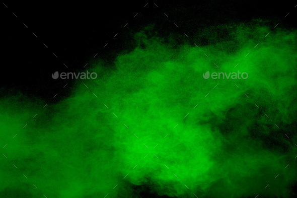 Abstract green powder explosion on black background.Freeze motion of ...