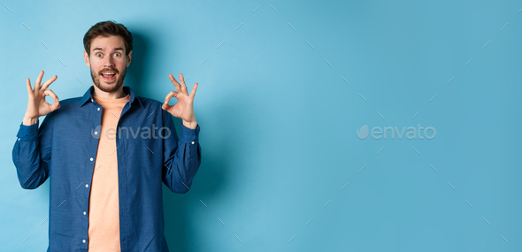 Impressed man praising something awesome, showing okay signs and ...
