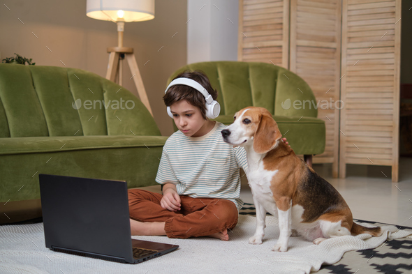 boy enjoys quality time with his pet while also staying productive with ...