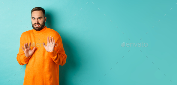 Alarmed guy shaking hands in rejection, declining and stepping away ...