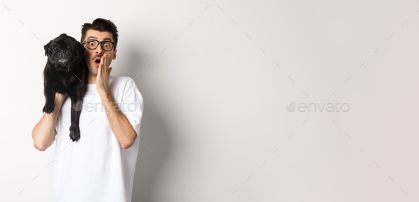 Image of shocked dog owner staring at camera and gasping impressed ...