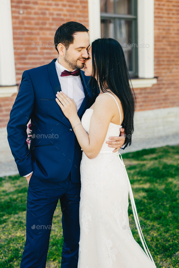 Just married bride and bridegroom kiss passionately, express real ...