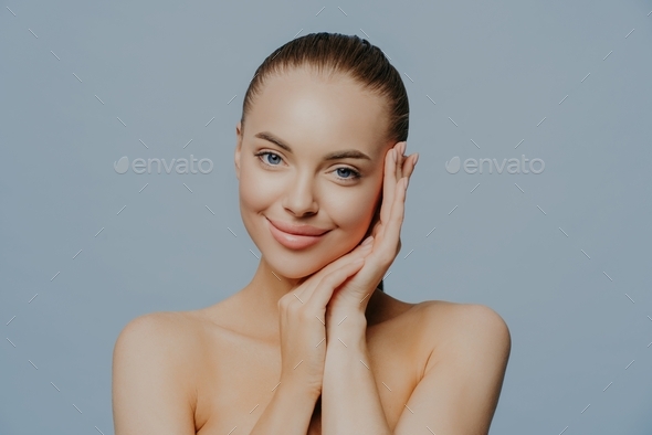 Beauty woman face portrait. Beautiful spa model girl with perfect fresh clean skin on blue ...