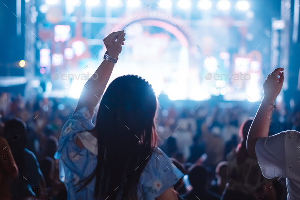 Crowd of hands up concert stage lights and people fan audience ...