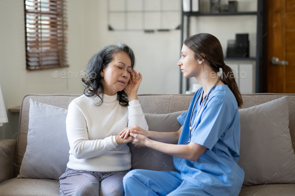 Female doctor holding female patient hands with compassion and comfort ...