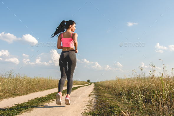 The sport woman running in the field path Stock Photo by artemp3 ...