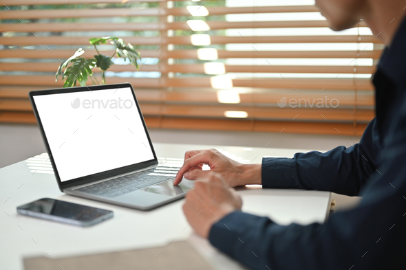 Side view hands of businessman typing on laptop computer keyboard at ...