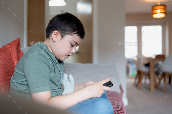 Kid using mobile phones typing text message,School Boy using cell phone ...