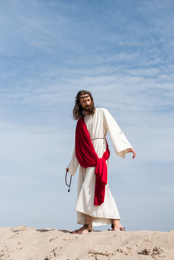 Jesus in robe, red sash and crown of thorns holding rosary and walking ...