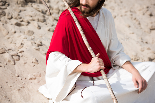 cropped image of Jesus in robe, red sash and crown of thorns sitting in ...