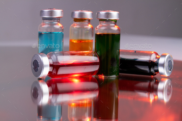 Collection of drug vials with colored solution. Stock Photo by ...