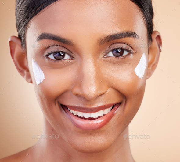 Portrait, face and cream with a model woman in studio on a beige ...