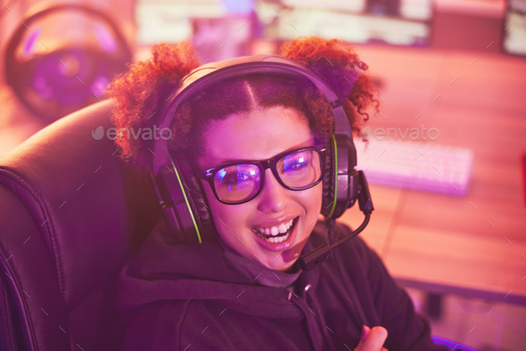 Happy streamer portrait, video game and girl with headphones in home of ...