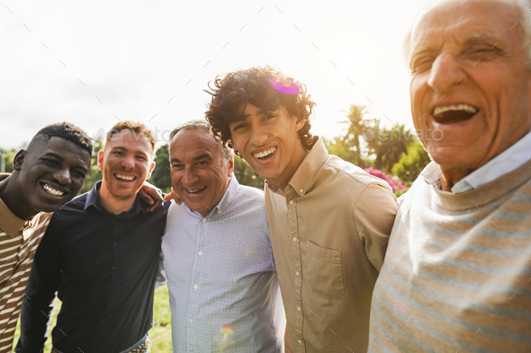 Multi generational men smiling in front of camera - Male multiracial ...