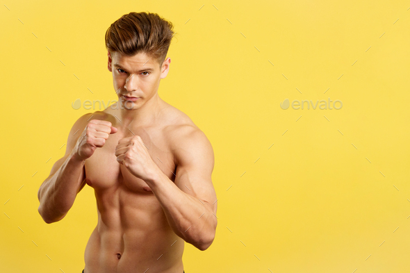 Strong male boxer standing with bare torso Stock Photo by ivanmorenosl
