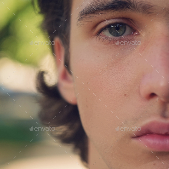 Half face of an young man. Close-up male eye - soft focus. Part of face ...