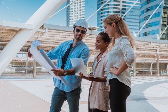 Engineer look at project blueprints for thinking about building project ...