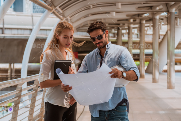 Engineer look at project blueprints for thinking about building project ...