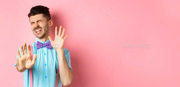 Crying guy asking to stop, raising hands up in defense, protecting ...