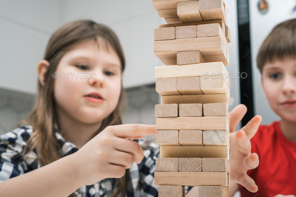 Concentrated and passionate children playing board game of balance ...