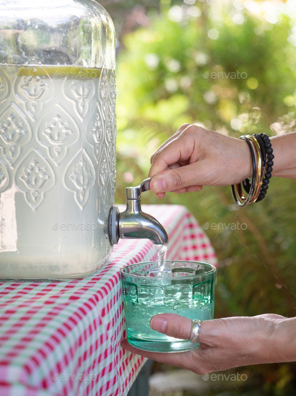 Crop person pouring lemonade in glass Stock Photo by anal74 | PhotoDune